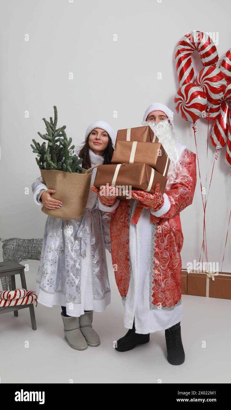 Slavic couple in national winter costumes with gifts Stock Photo - Alamy