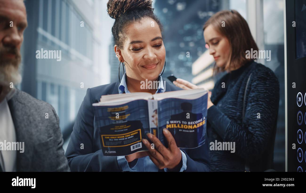 Female riding elevator reading book hi-res stock photography and images ...