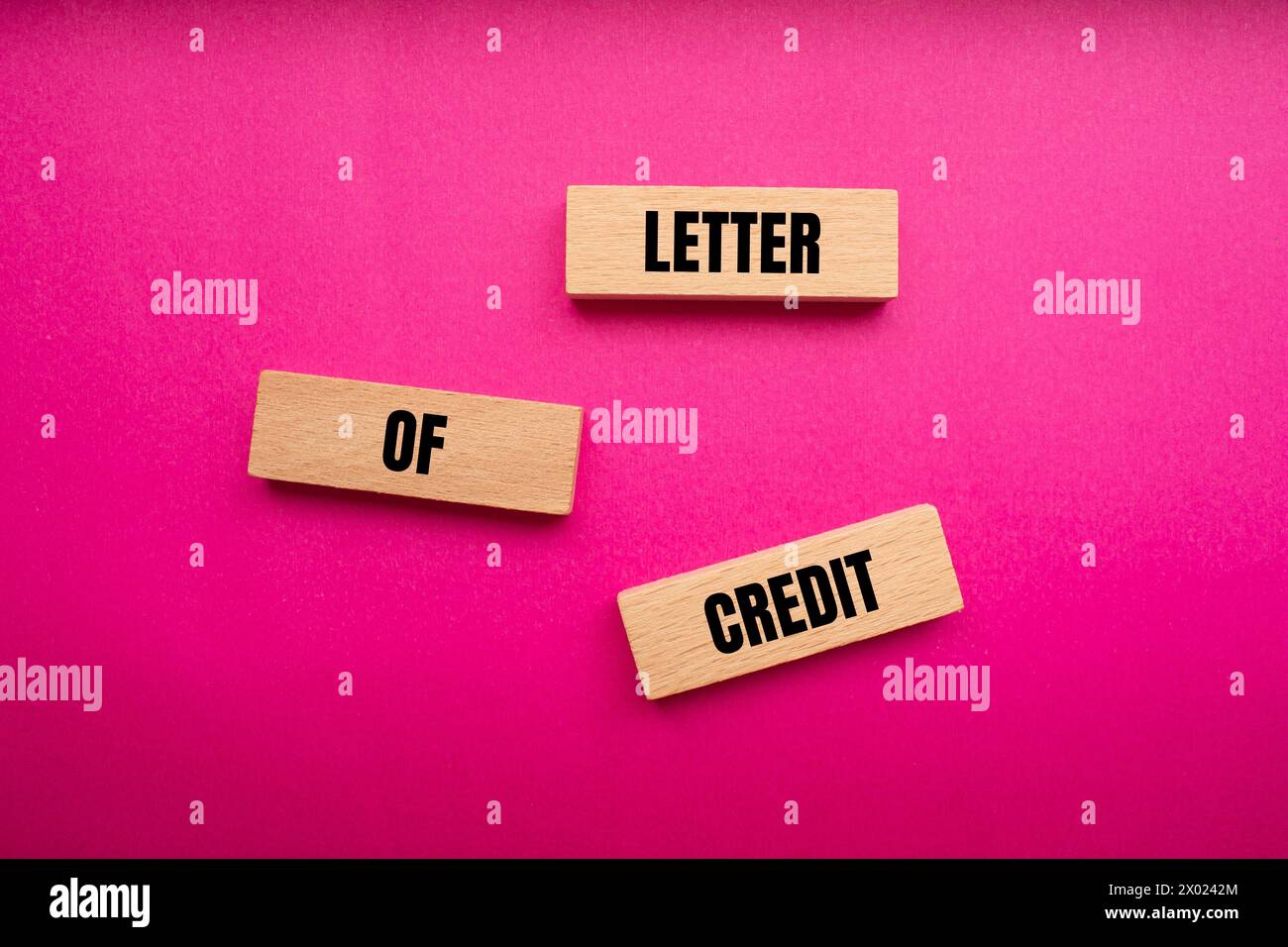 Letter of credit words written on wooden blocks with pink background ...
