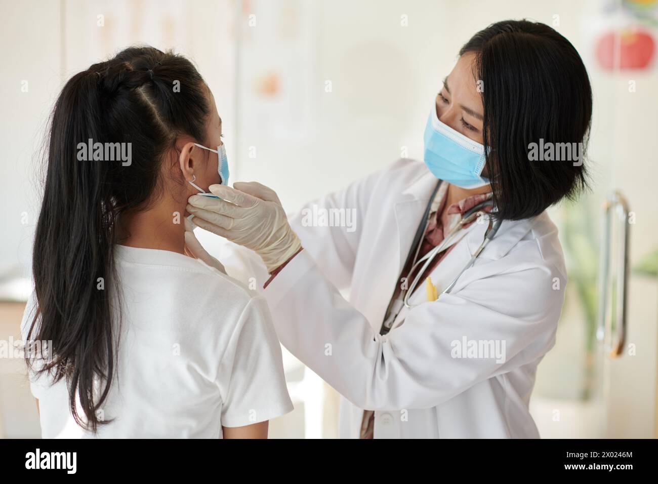Pediatrician palpating neck lymph nodes of teenage girl Stock Photo - Alamy