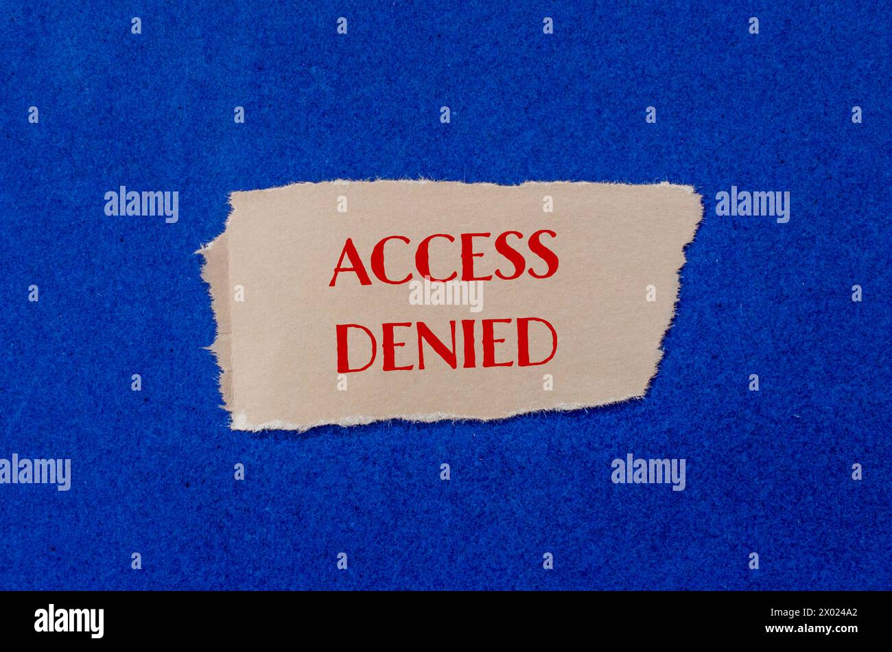 Access denied words written on ripped paper with blue background ...