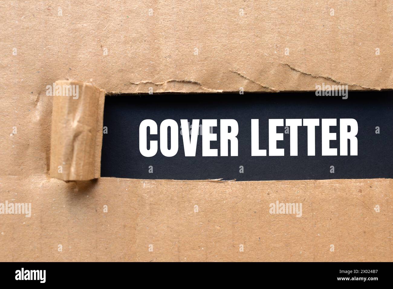 Cover letter words written on ripped paper with black background ...