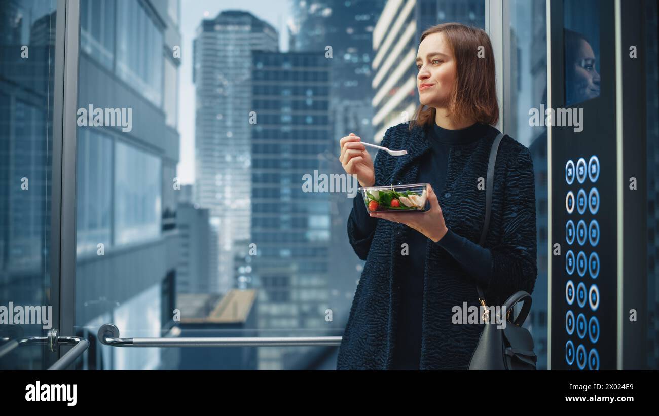 Woman eating salad in elevator hi-res stock photography and images - Alamy
