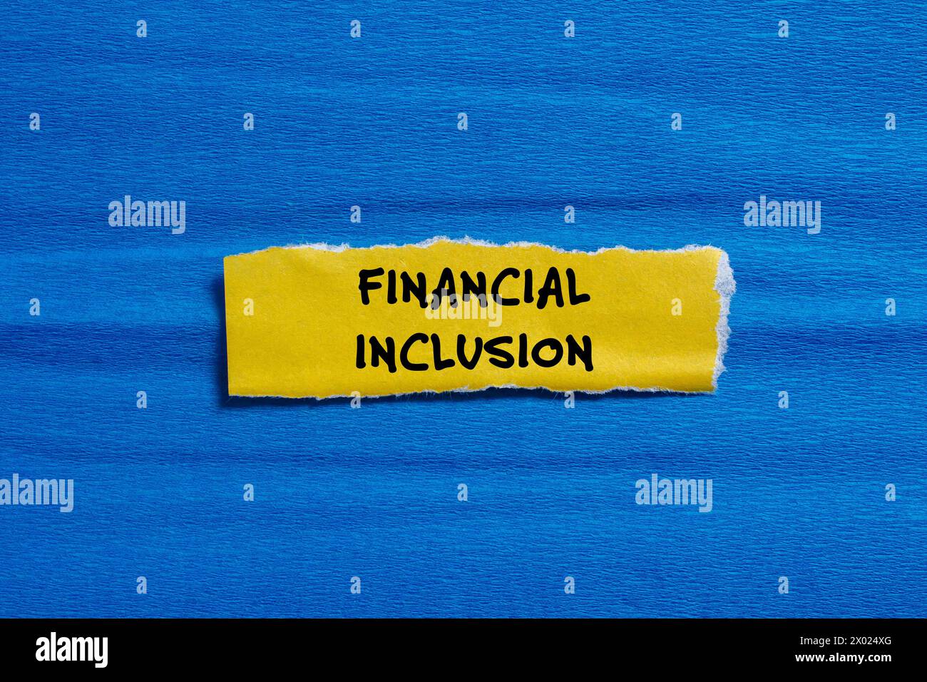 Financial inclusion words written on ripped paper with blue background ...