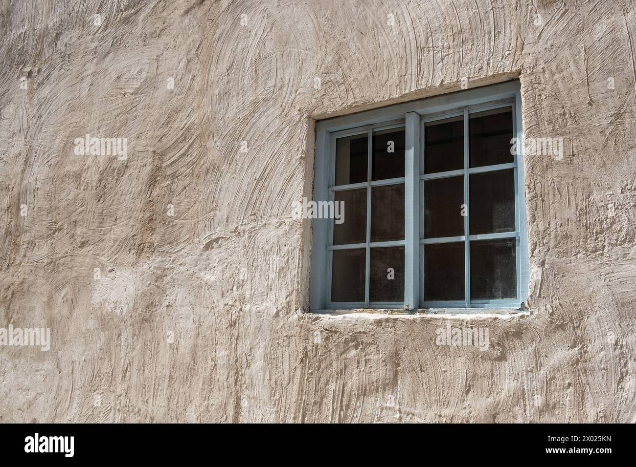 A simple wooden framed window in an adobe plastered wall Stock Photo ...