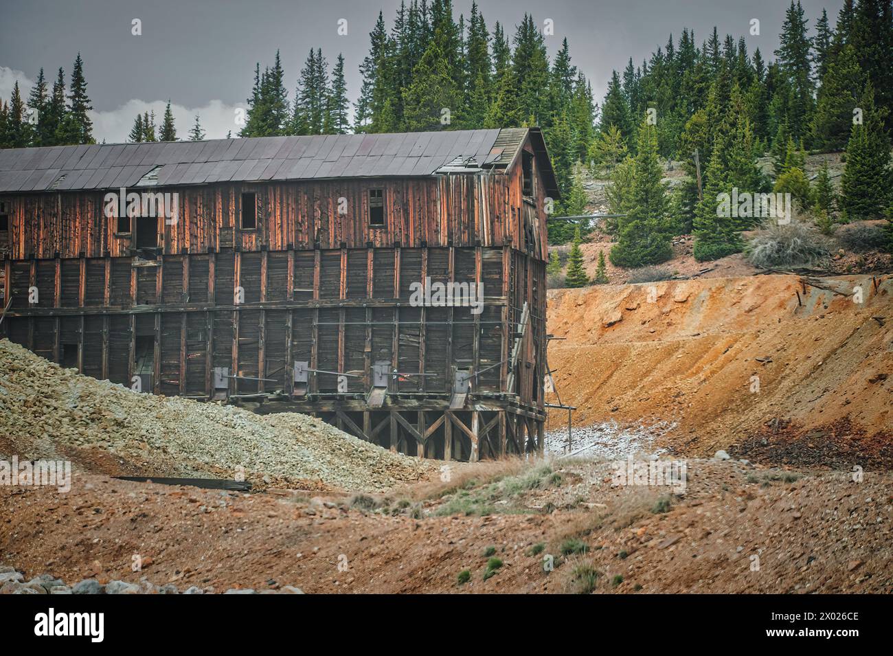 Majestic old mining building paired with pine trees and a rugged ...