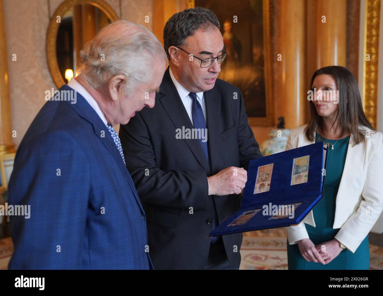 King Charles III (left) is presented with the first banknotes featuring ...