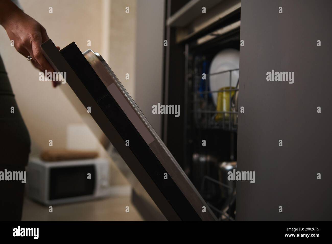 Close-up housewife's hand opening or closing the door of a modern ...