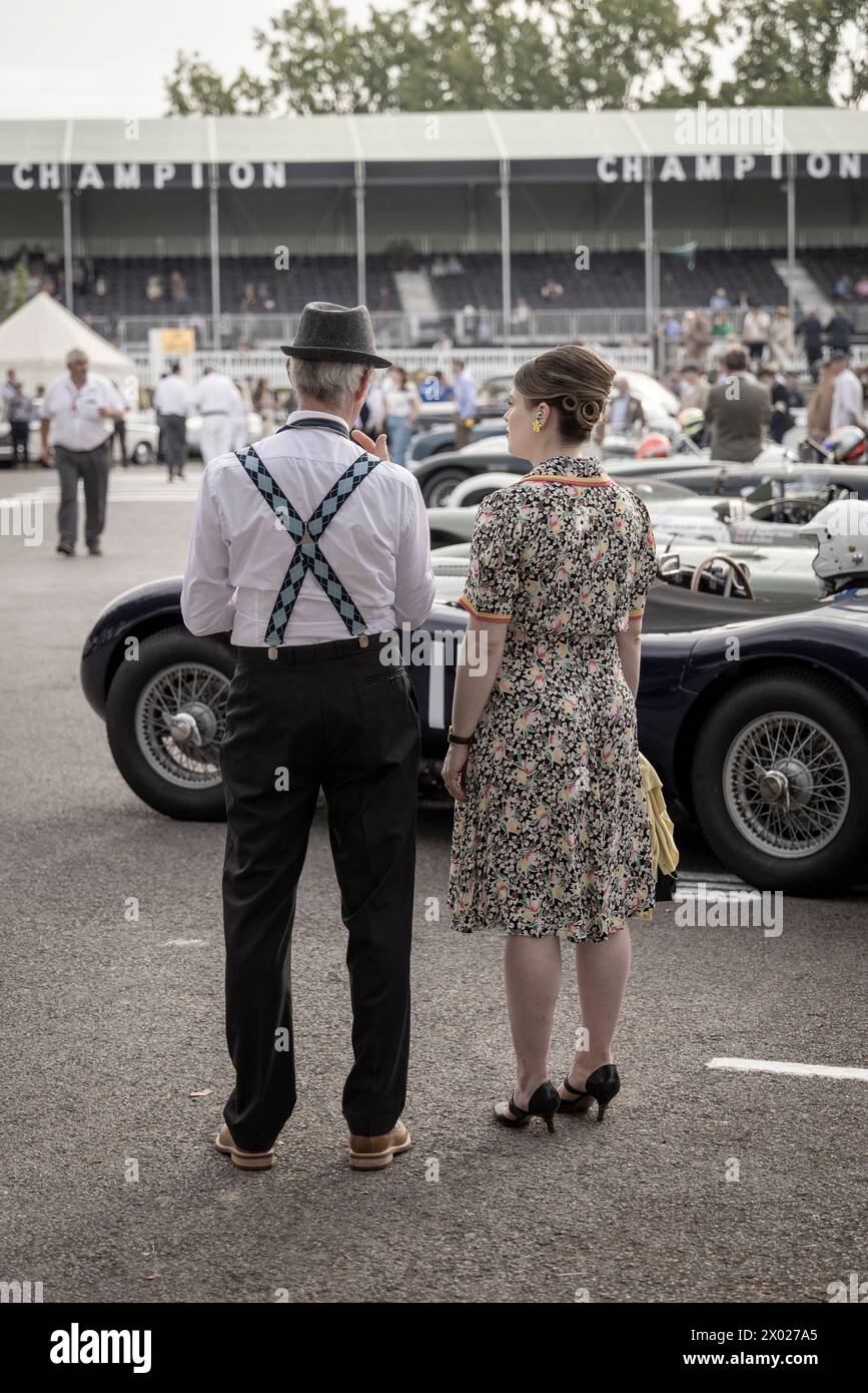 Period dress and historic racing cars assembled in the holding paddock ...