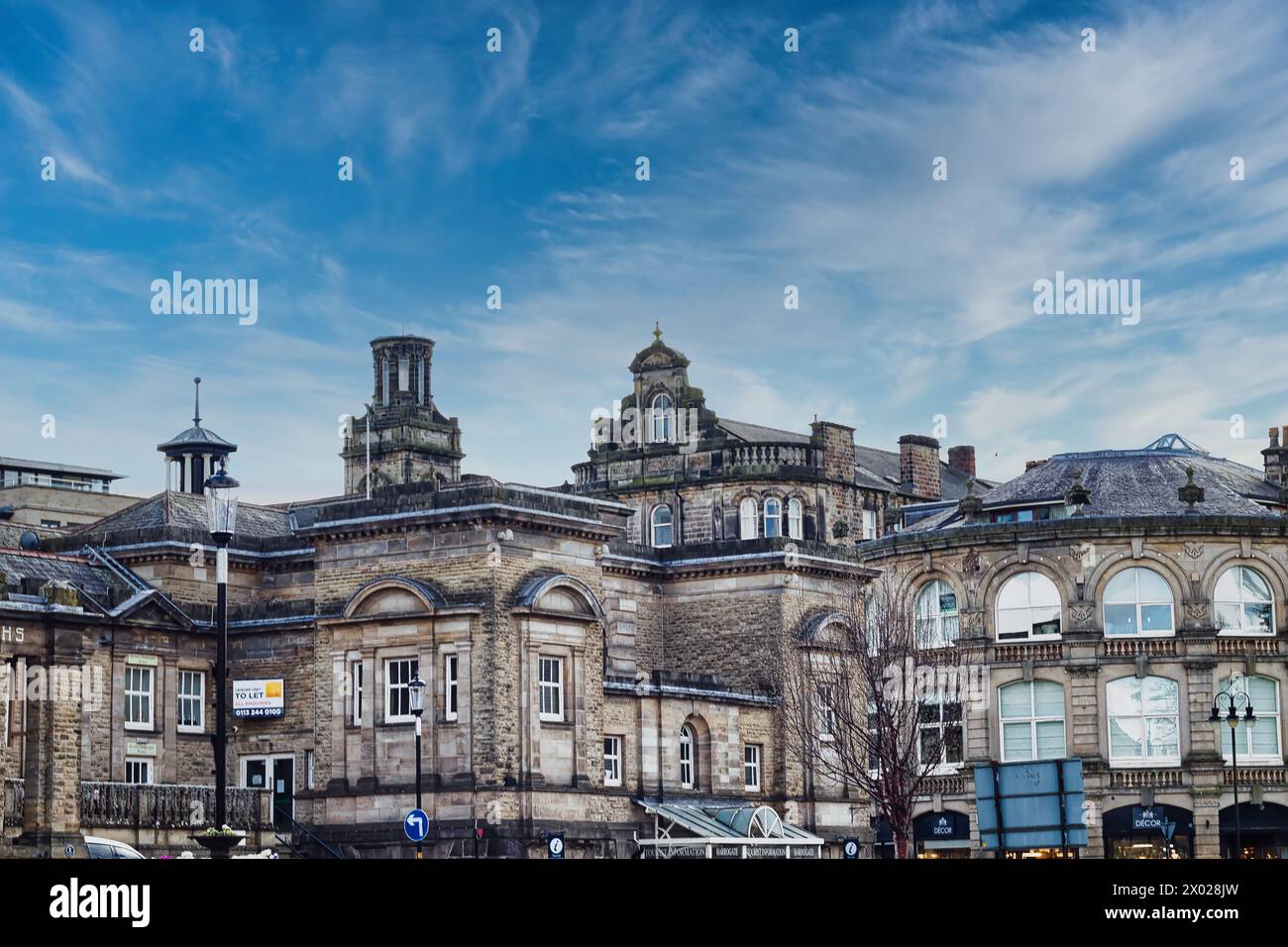 Classic European architecture under a dynamic sky with wispy clouds ...