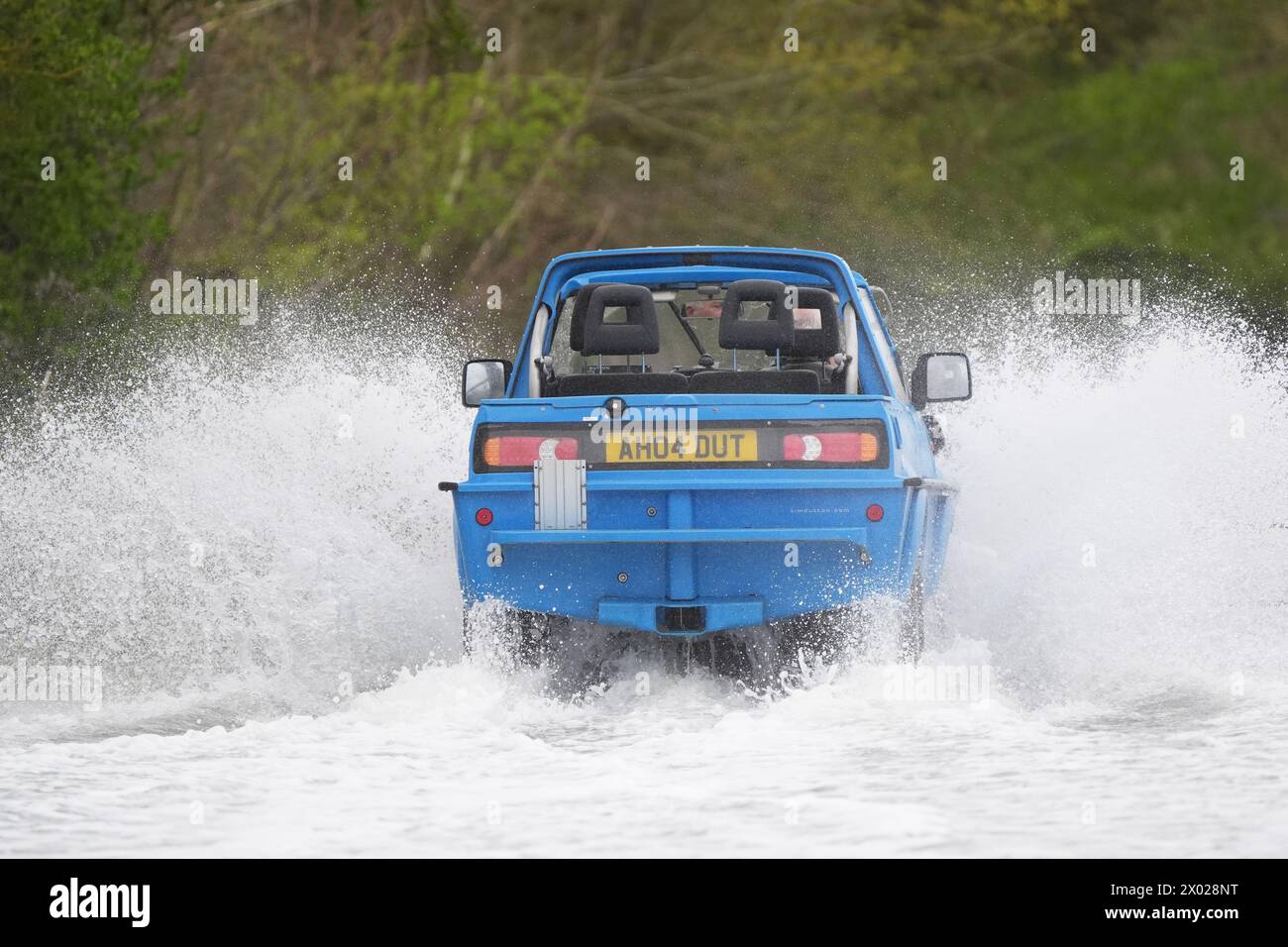 A car drives through flood water in Littlehampton, West Sussex, after ...