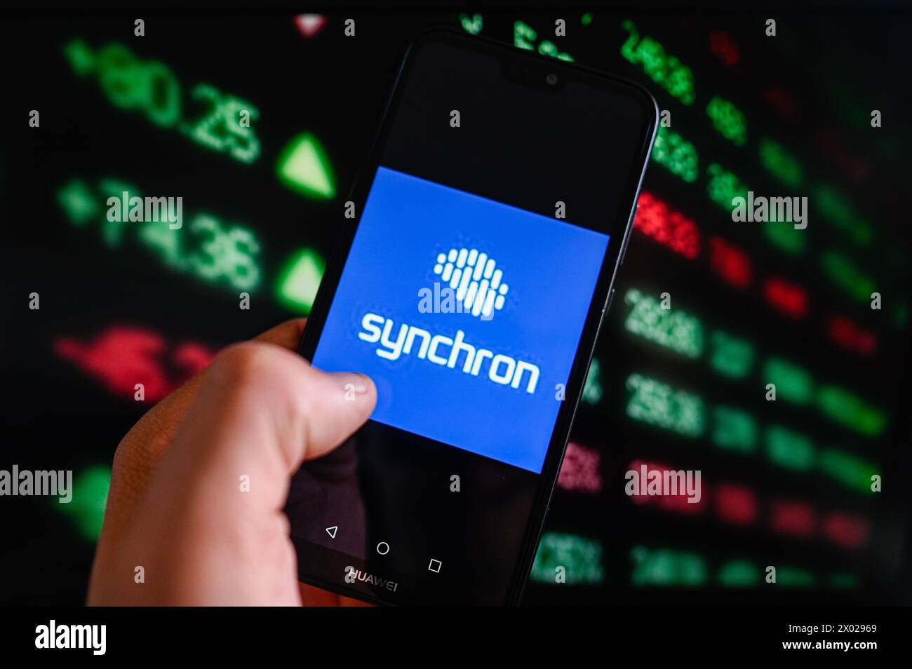 In this photo illustration, a Synchron logo is displayed on a ...