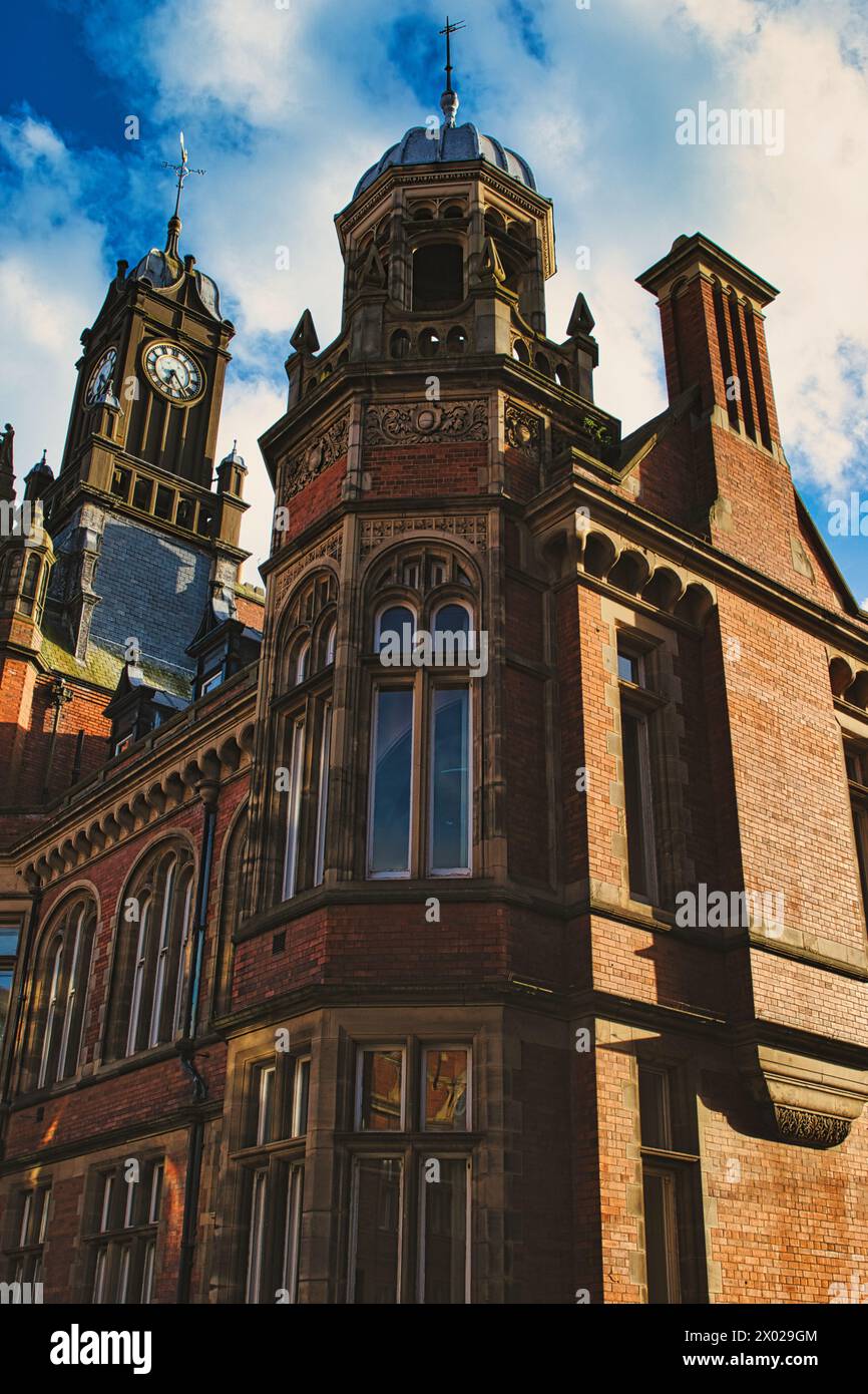 Victorian architecture with a clock tower under a blue sky, showcasing ...