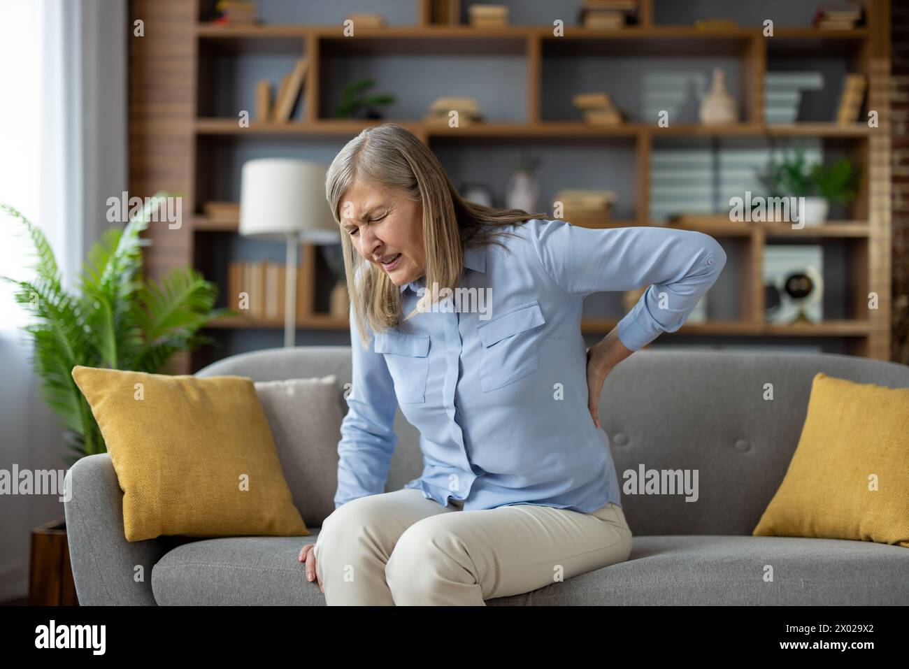 Woman standing on couch hi-res stock photography and images - Alamy