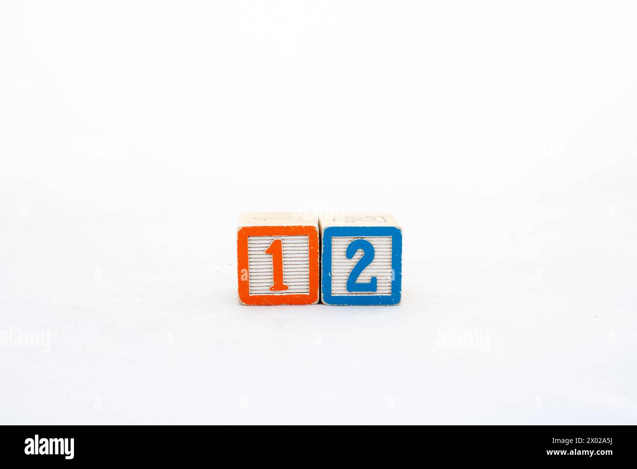 Wooden blocks one and two numbers on white background with copy space ...