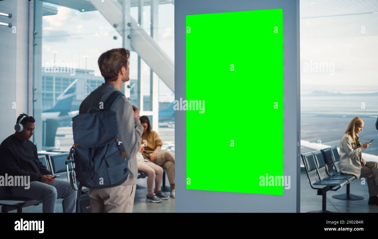 Airport Terminal: Young Man Looking for His Fligt at Green Chroma Key ...