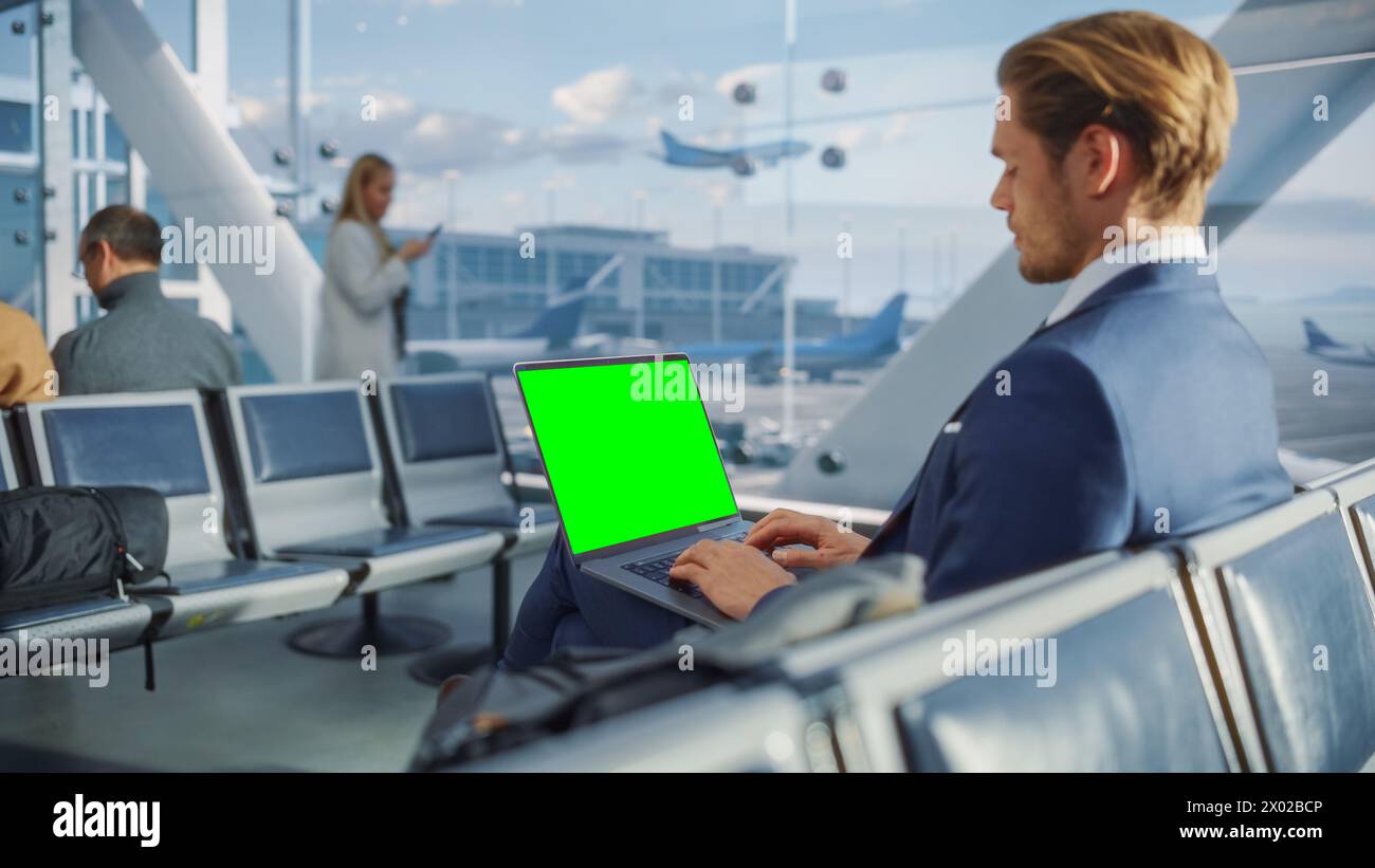 Airport Terminal: Businessman Working on Green Chroma Key Screen Laptop ...