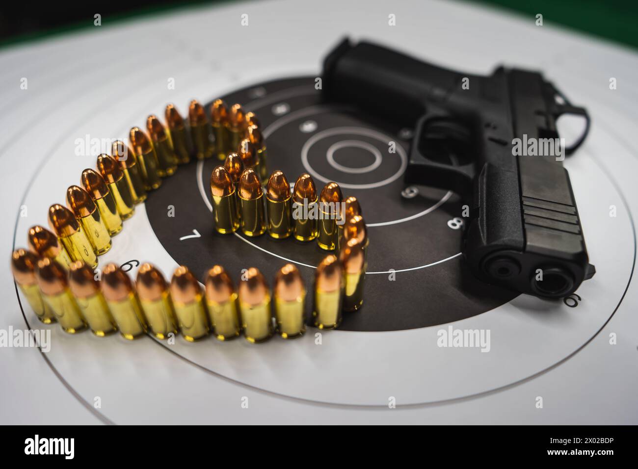 A shooting target, a modern 9mm pistol and a heart made of cartridges ...