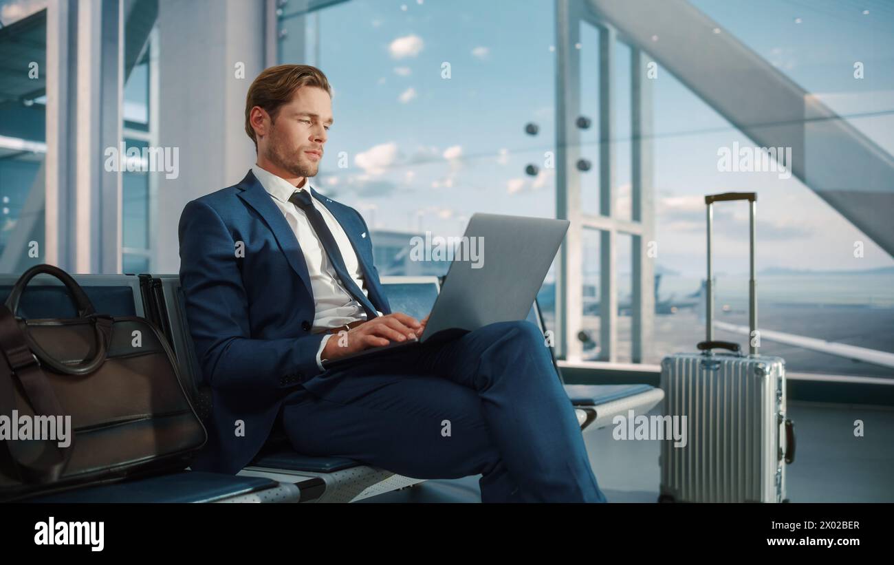 Airport Terminal: Businessman Uses Laptop Computer, Waiting for a ...