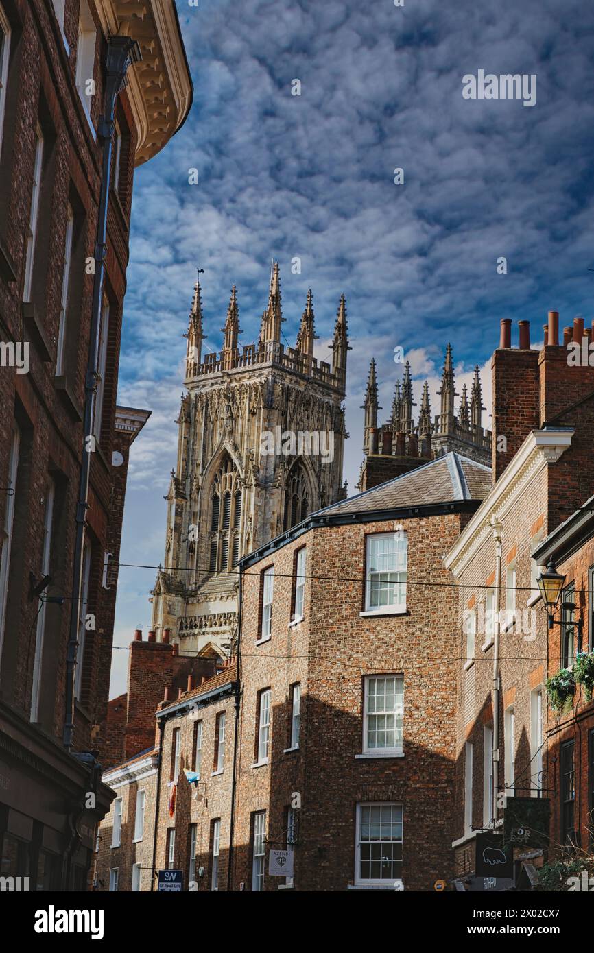 Quaint cobbled street leading to a majestic Gothic cathedral under a ...