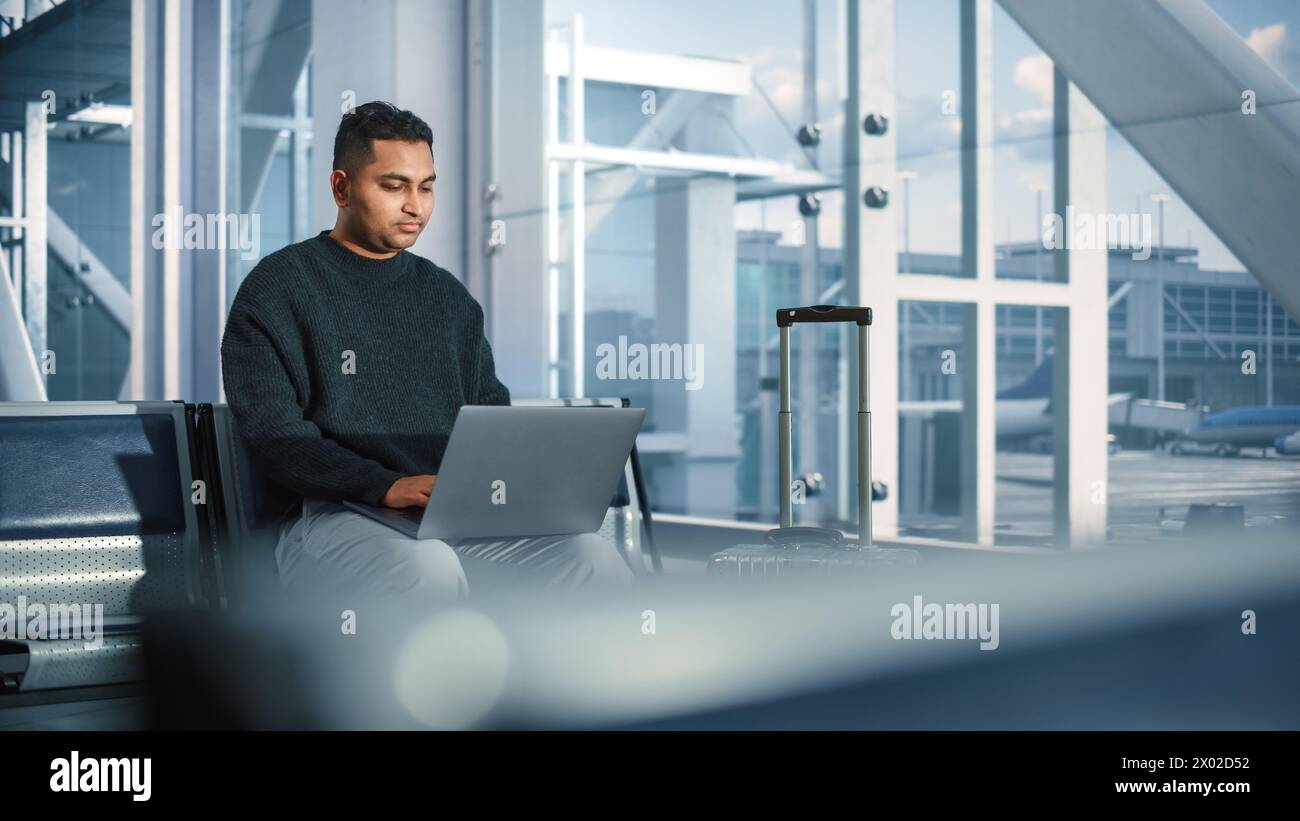 Man sitting airport uses laptop hi-res stock photography and images - Alamy