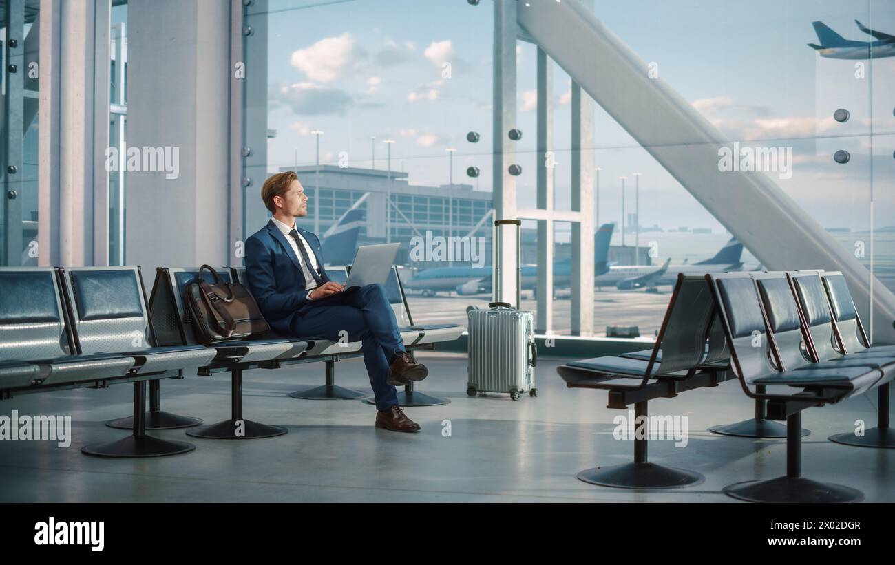 Airport Terminal: Businessman Uses Laptop Computer, Waiting for His ... Airport Terminal: Businessman Uses Laptop Computer, Waiting for His ...