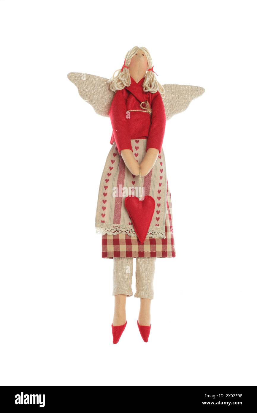 Vintage doll in linen dress holding red heart on white background Stock ...