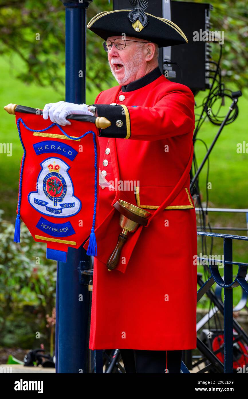 Male town crier (colourful crier's uniform, loud voice) proclaiming ...