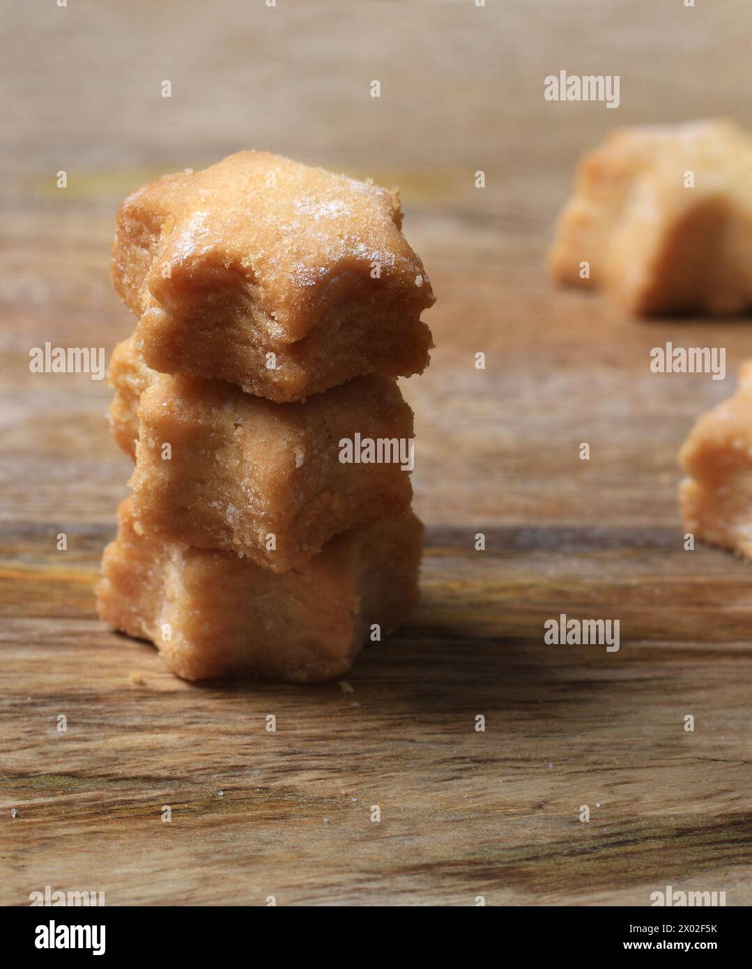 Freshly baked alfajores shortbread biscuits shaped as stars. stacked up ...