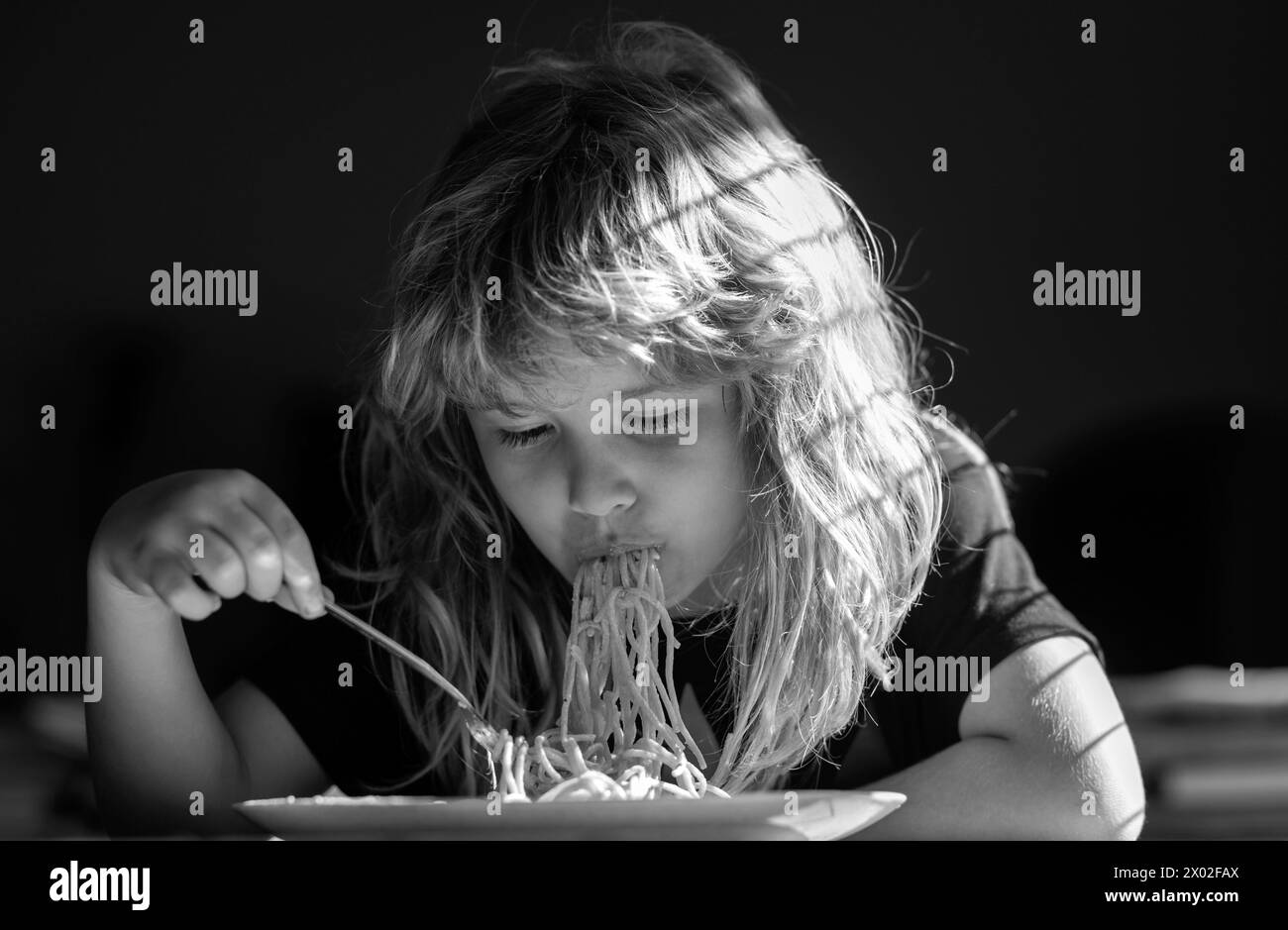 Young kid sitting on the table eating healthy food with funny ...