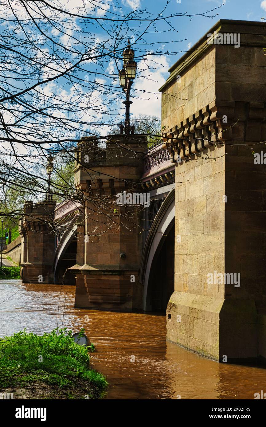Scenic view of an old stone bridge with arches over a river, framed by ...