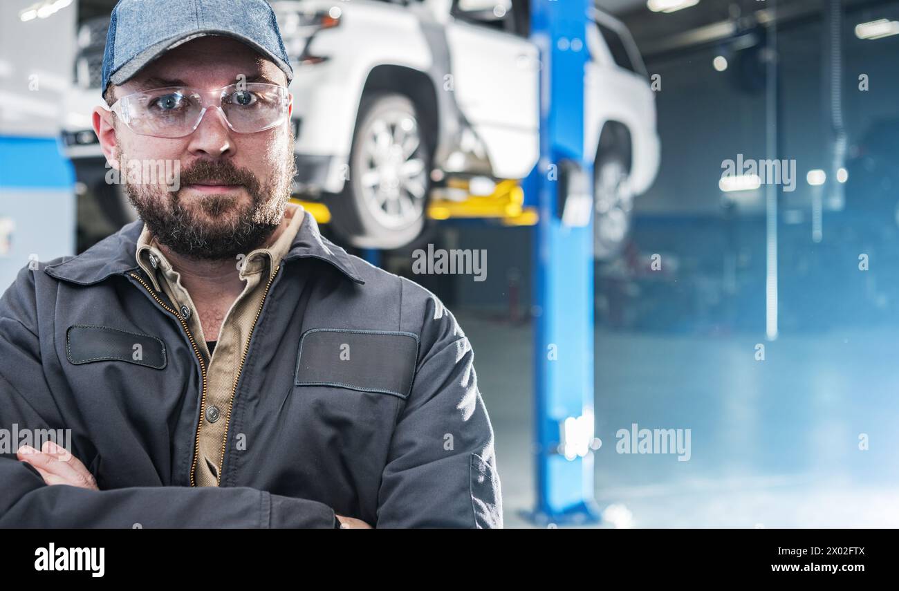 Mechanic repairing lifted car hi-res stock photography and images - Alamy