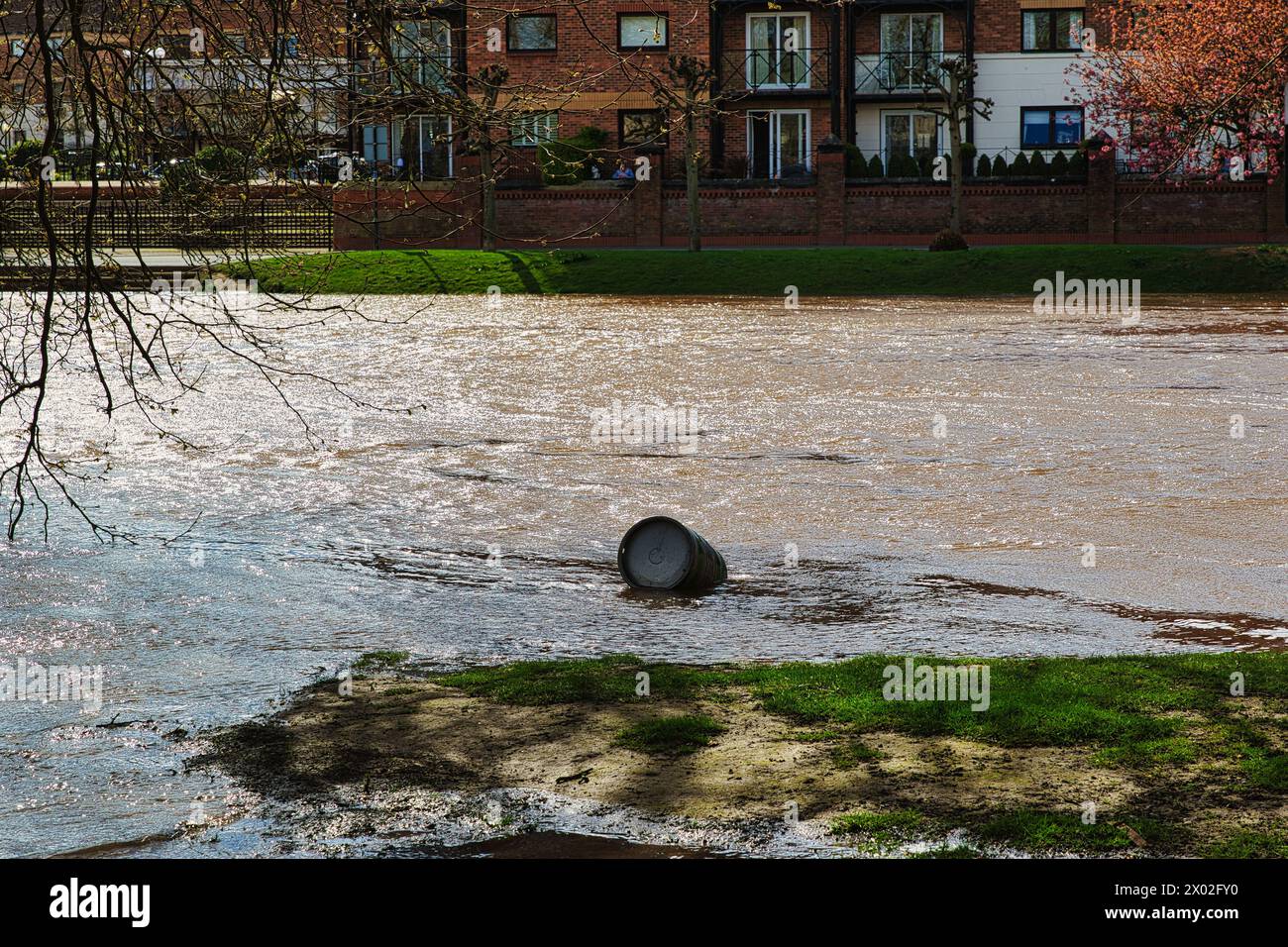 Polluted river with a discarded tire floating on the water's surface ...