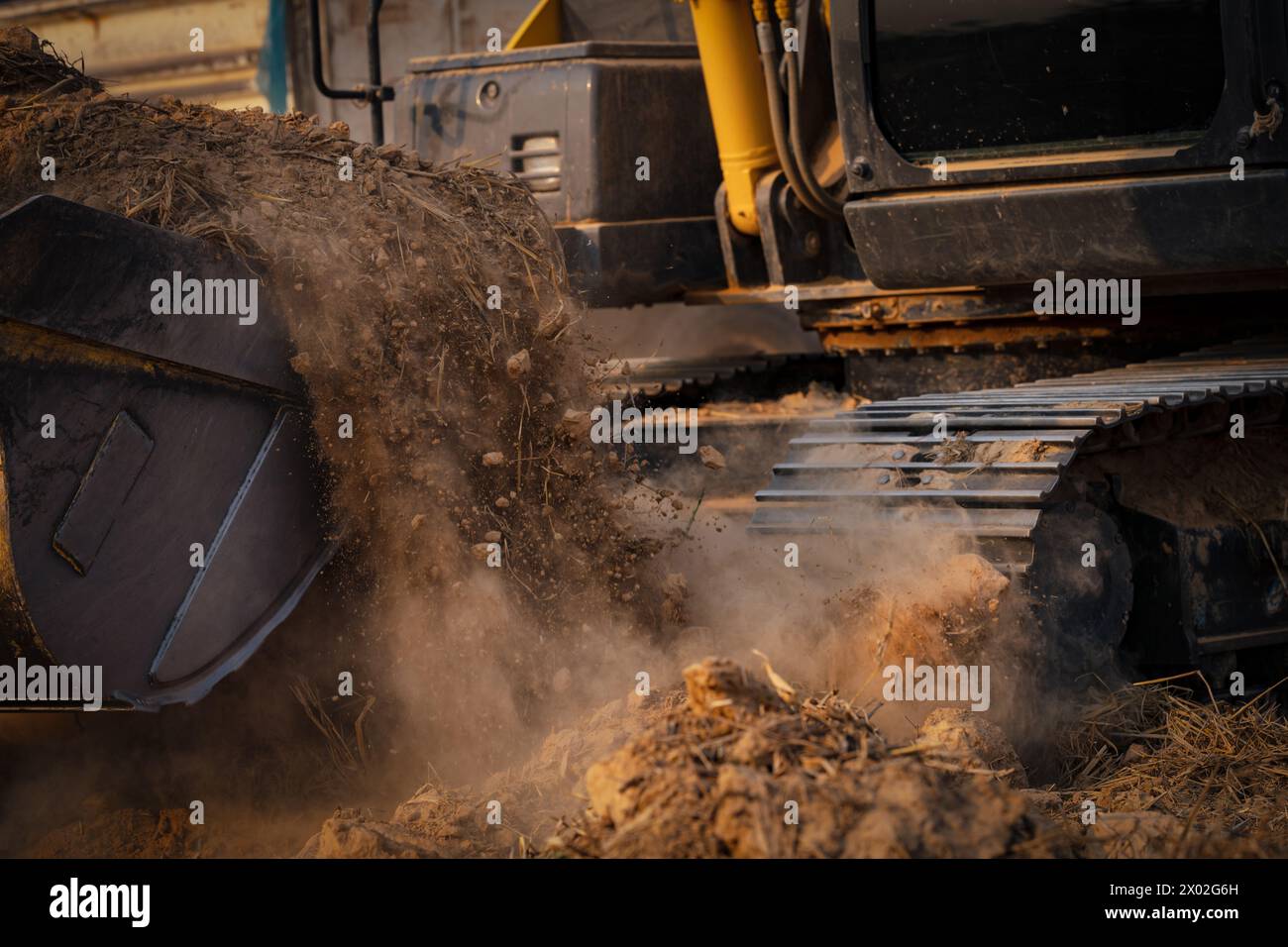 Selective focus on metal bucket teeth of backhoe digging soil. Backhoe ...