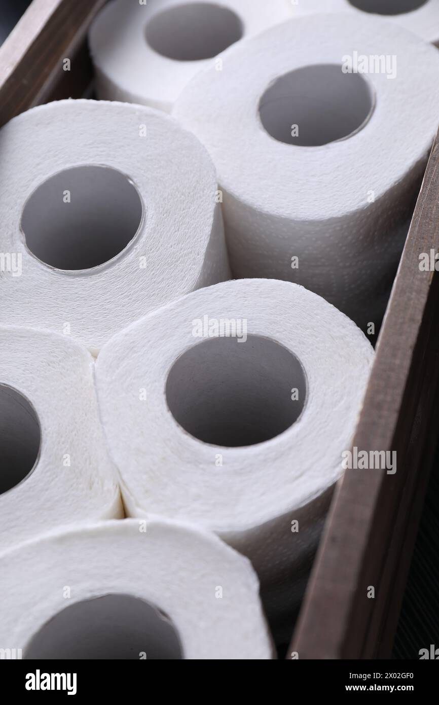 Many toilet paper rolls in wooden crate Stock Photo - Alamy