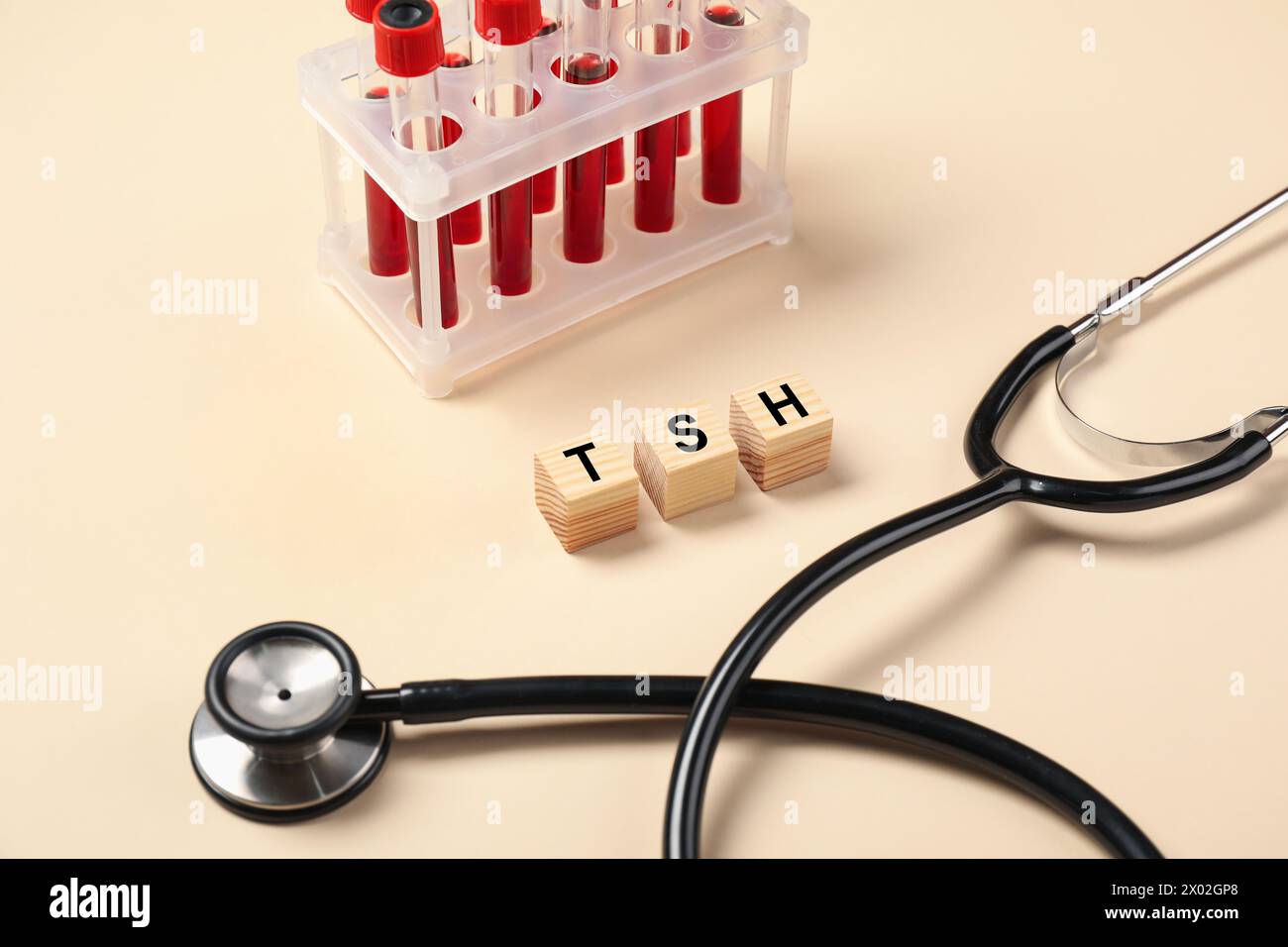Endocrinology. Stethoscope, wooden cubes with thyroid hormones and ...