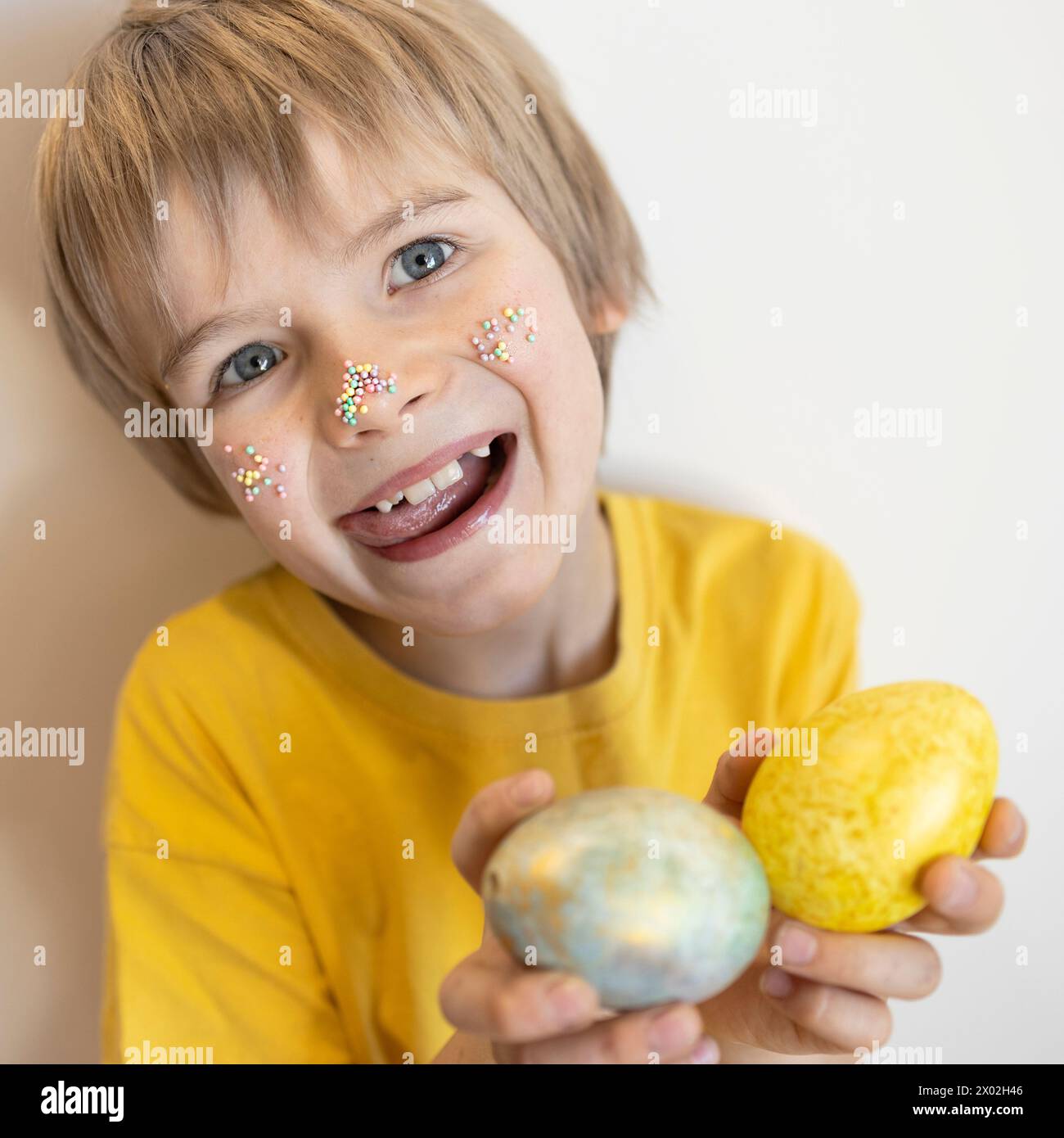 family is preparing for Easter. The child is having fun, stuck a ...