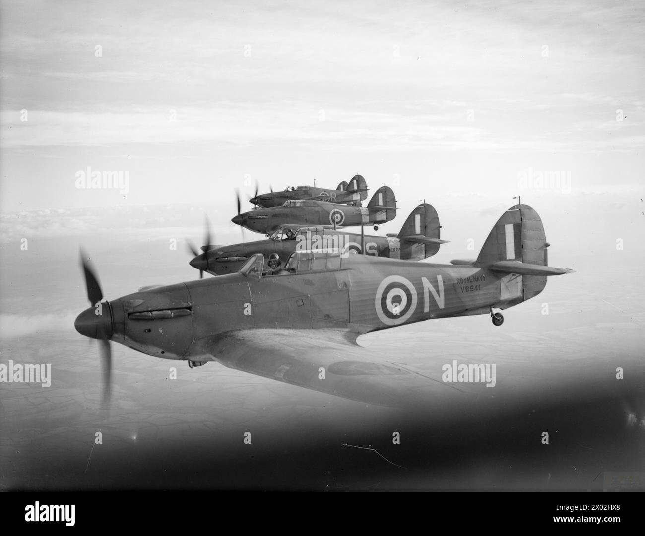 Hawker Sea Hurricanes of the Fleet Air Arm are shown flying in ...