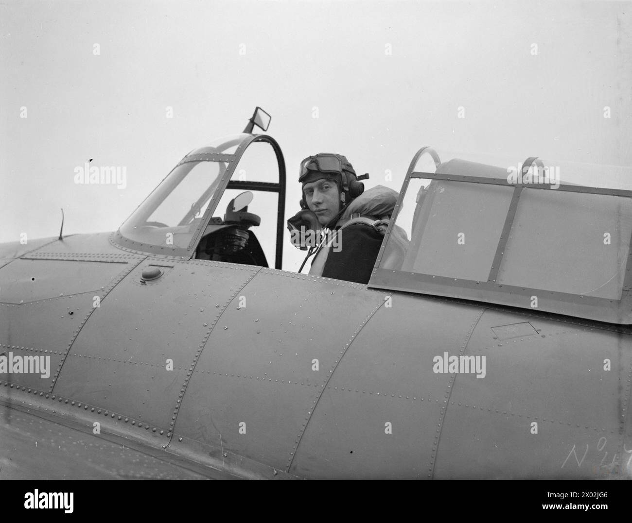 FLEET AIR ARM SERIES, ON BOARD HMS VICTORIOUS. SEPTEMBER 1942. - A naval pilot in his cockpit ...