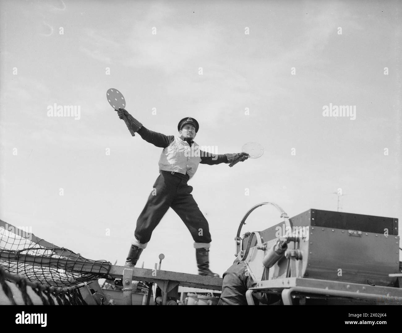 HMS AVENGER. 27 JUNE 1942. - The "Bats" officer signalling to a Hawker ...