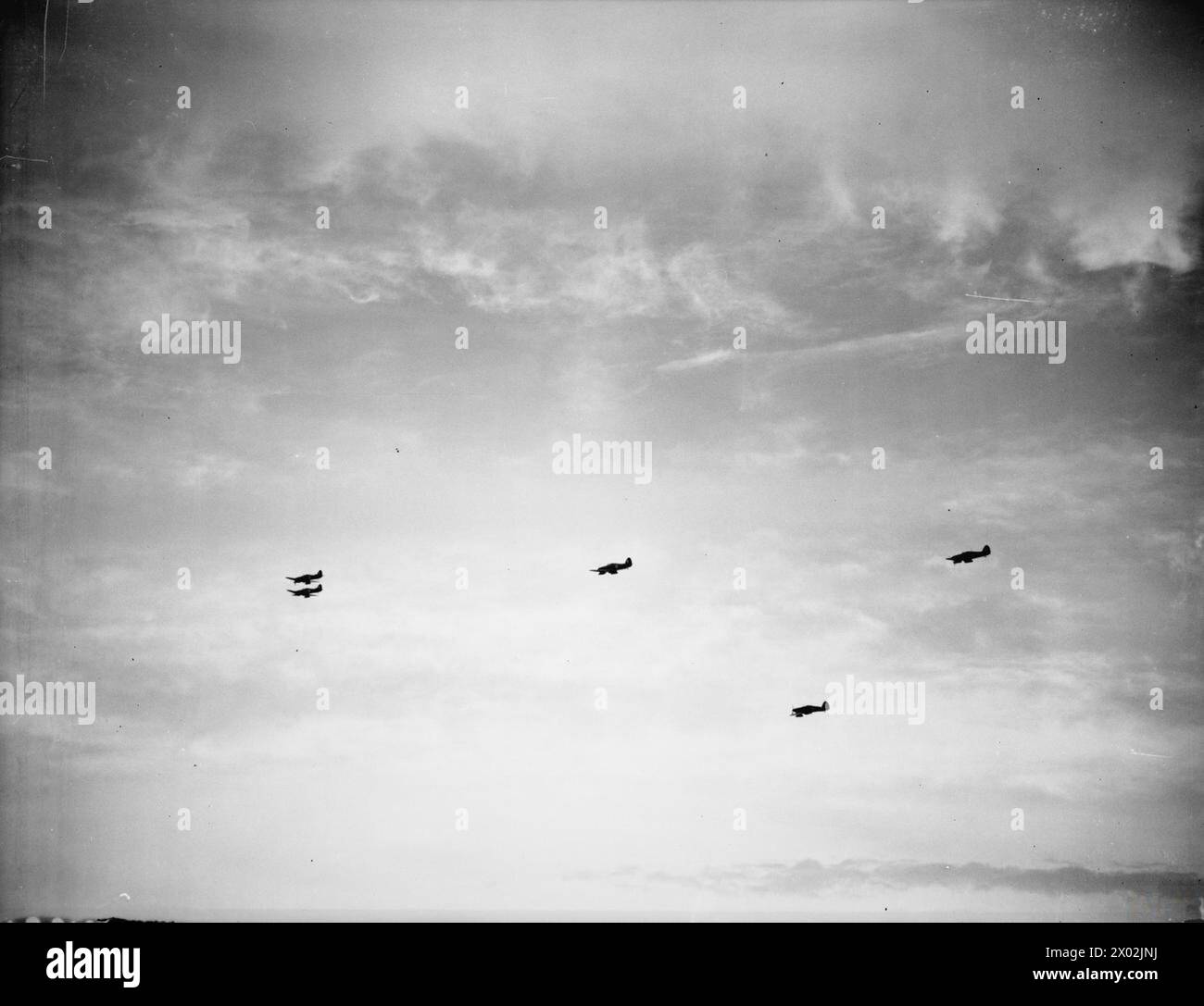 ON BOARD THE CRUISER HMS SHEFFIELD. MAY 1941, AT SEA. - A flight of Hawker Hurricane fighters ...