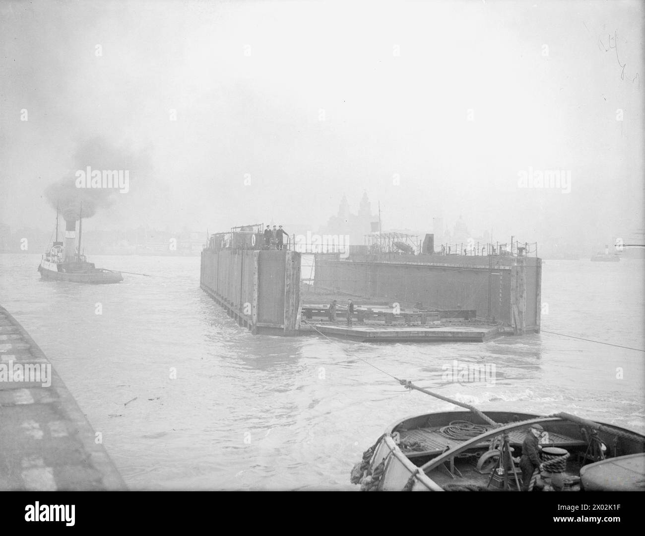 FLOATING DOCK IS TOWED OUT EAST. 28 MARCH 1945, ALFRED LOCK, BIRKENHEAD ...