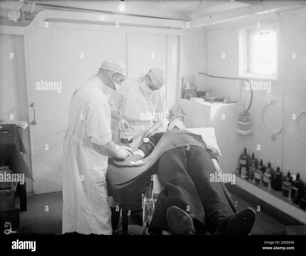 BLOOD TRANSFUSION ABOARD A NAVAL HOSPITAL SHIP. 15 JULY 1943, SCAPA ...