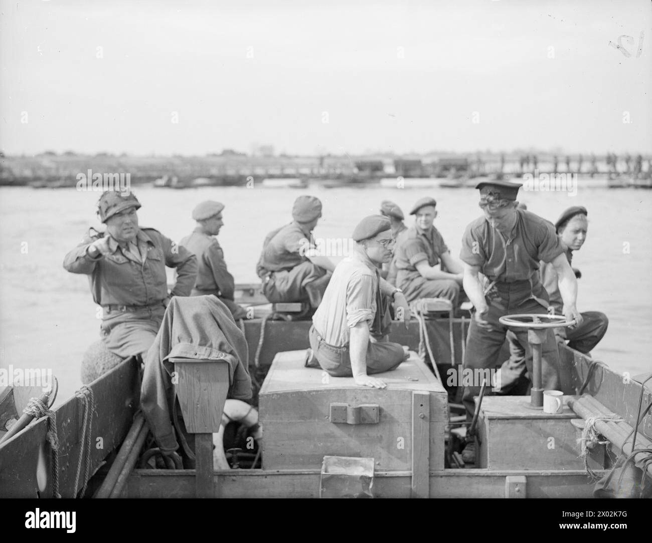Royal Navy landing craft carry British sappers across the Rhine below ...