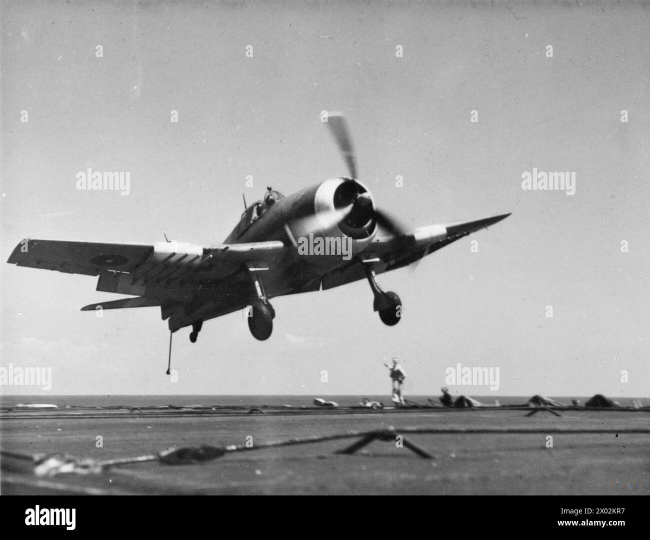 In April 1945, naval airmen aboard HMS Khedive in eastern waters direct ...