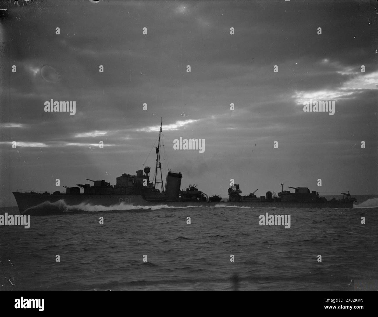HMS Kipling, a Royal Navy destroyer in 1940, is shown with guns manned ...