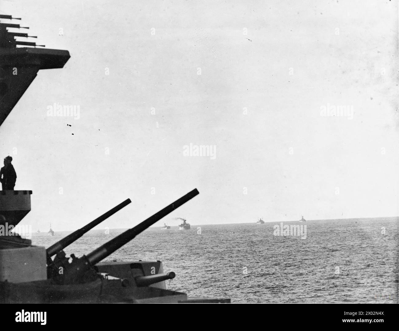 ON BOARD THE BATTLESHIP HMS RODNEY AT SEA. 1940. - Long focus shot of ...