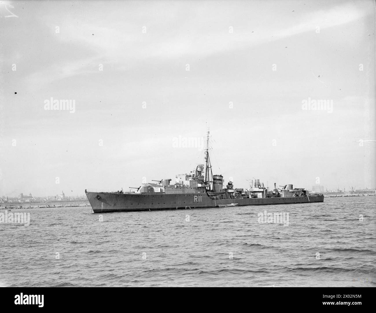 HMS Tumult, a T-class destroyer, is shown off the coast of Naples ...