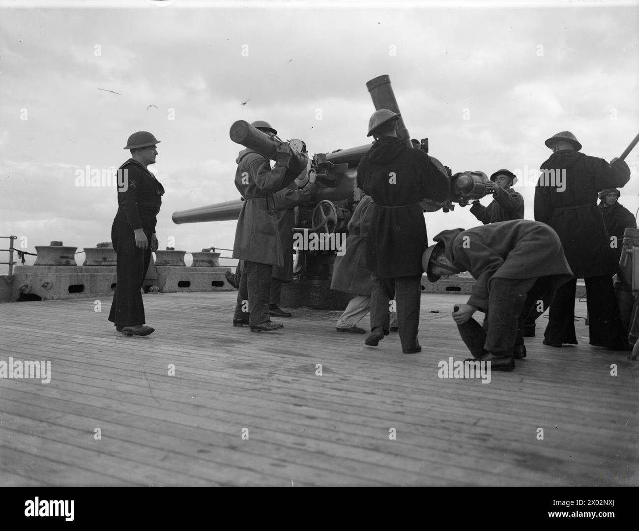 The Cunard liner Queen Mary in grey-white war paint prepares for an ...