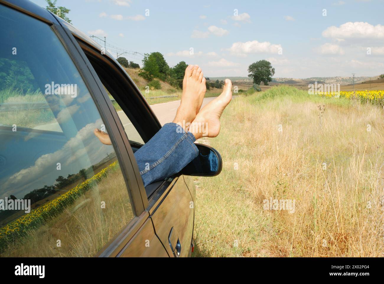 Man's feet sticking out of a car Stock Photo - Alamy